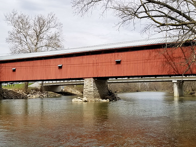 From this angle, you can appreciate how the bridge stretches across the Great Miami River, a ribbon of history connecting two shores.