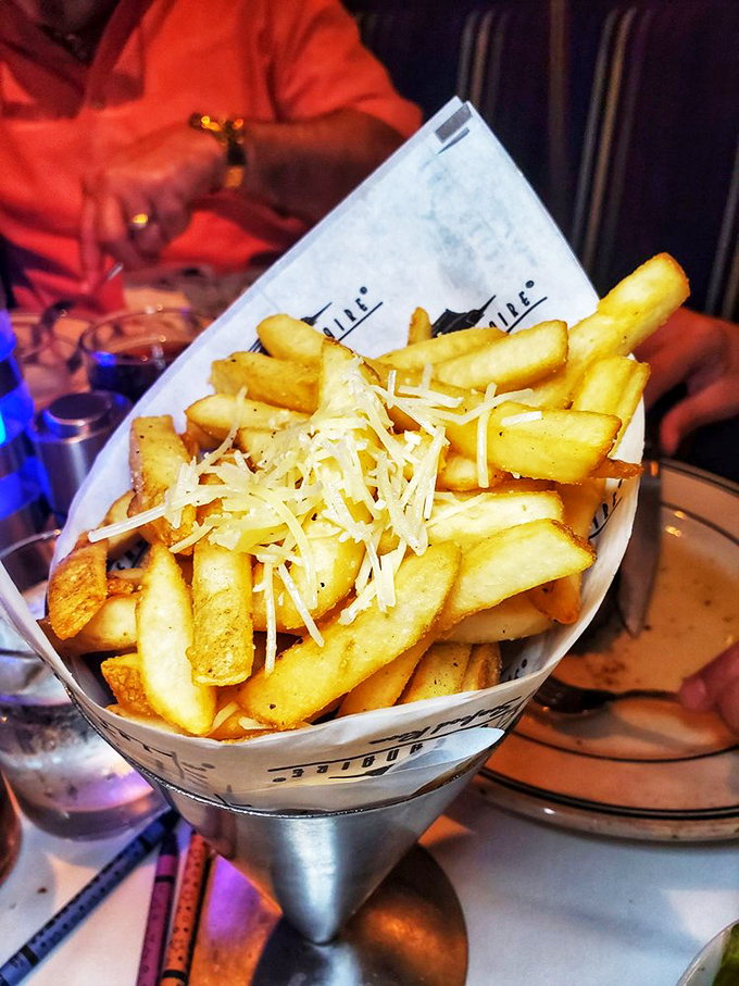 Parmesan truffle fries&mdash;because regular fries never went to finishing school. Served in a metal cone that says, "Yes, I'm fancy potatoes."