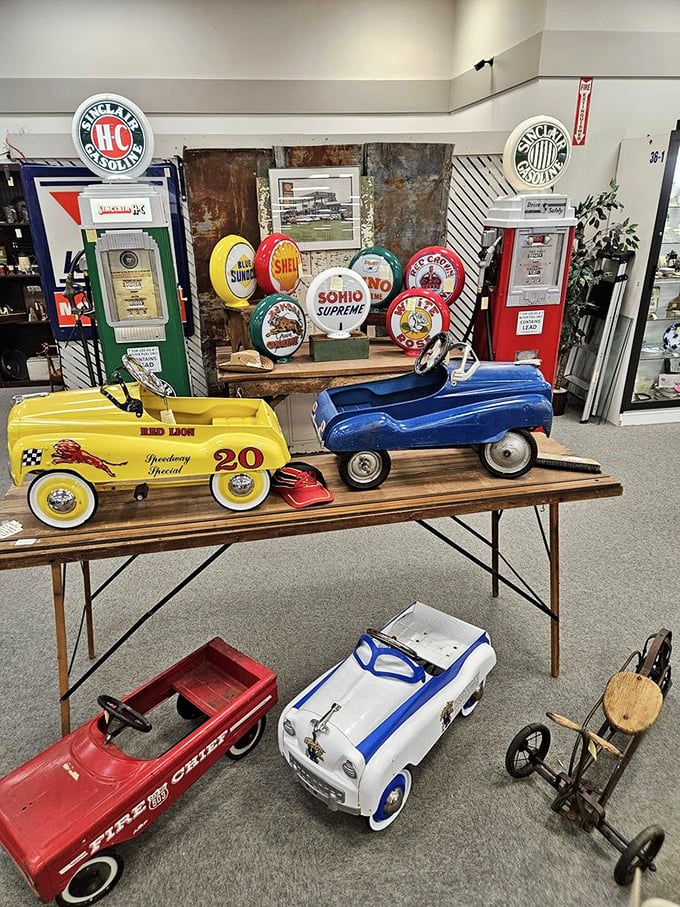 Pedal cars and vintage gas station signs create a miniature highway through automotive history.