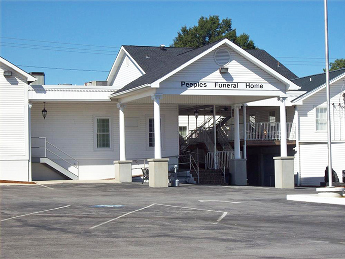 Even Peeples Funeral Home embraces the town's architectural harmony, its white columns offering dignity in life's most difficult moments.