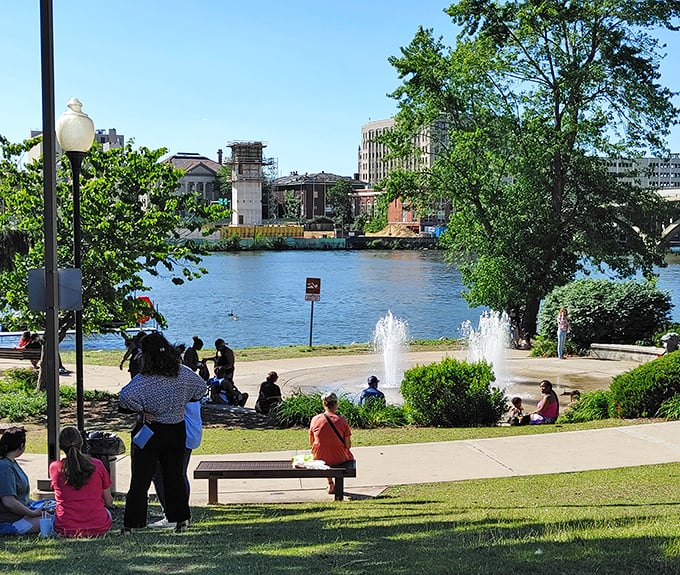 Riverside parks offer front-row seats to nature's daily performance, where locals gather to enjoy fountain-side relaxation without big-city price tags.