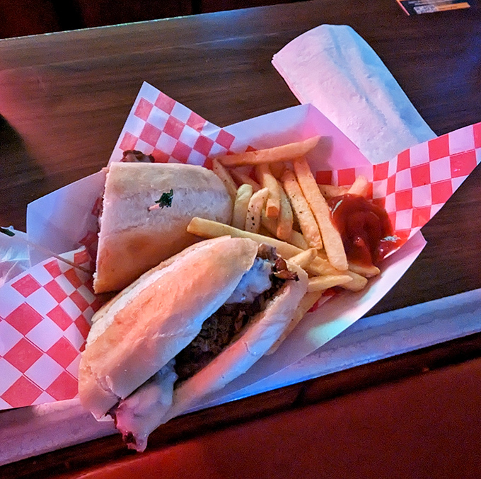 The Philly cheesesteak, served unpretentiously in red checkered paper, proves you don't need to cross state lines for authentic comfort food perfection.