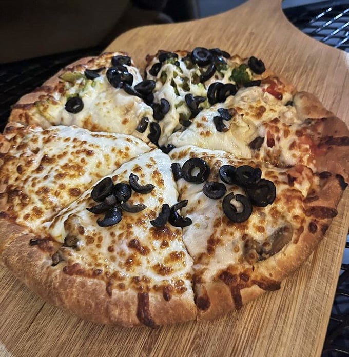 This isn't artisanal wood-fired pizza with imported buffalo milk cheese&mdash;it's honest, melty, olive-topped comfort on a perfectly browned crust.