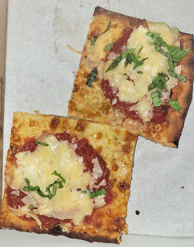 Square slices with that perfectly crisp edge—the kind that makes you wonder why you ever settled for round pizza in the first place.