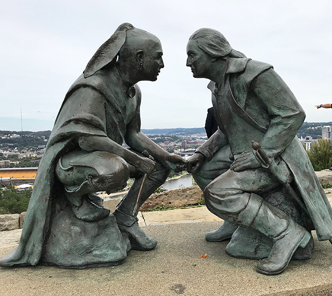 This sculpture captures the timeless moment when strangers become friends over a shared beautiful view.