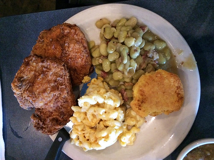 Comfort on a plate: crispy fried protein alongside creamy mac and cheese, with lima beans adding that distinctive Southern touch.