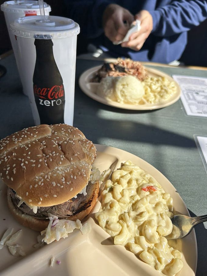 This isn't just a sandwich; it's an engineering marvel of smoked meat, soft bun, and creamy mac and cheese that somehow maintains structural integrity.