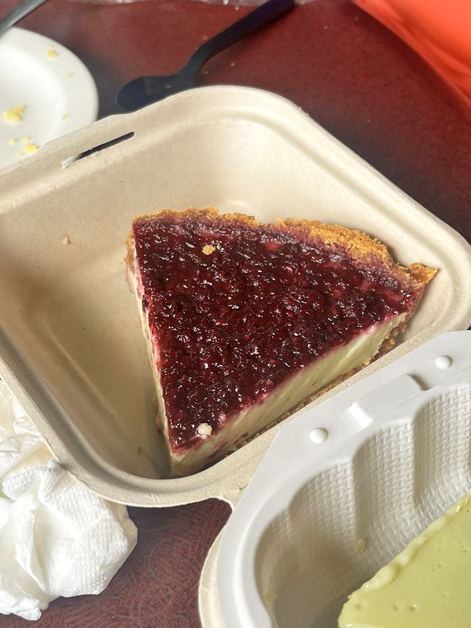 Beneath that ruby-red raspberry topping lies a creamy filling that makes you wonder why pie isn't considered an acceptable breakfast.