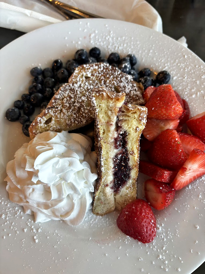 French toast with a surprise filling&mdash;like finding hidden treasure. The whipped cream and fresh berries are just showing off now.