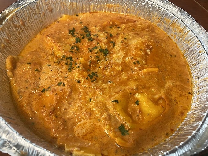 Ravioli swimming in sauce like it's taking a luxurious Italian spa day on your plate.