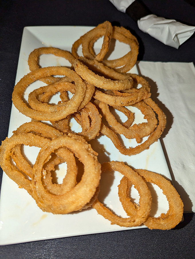 Onion rings stacked higher than my retirement dreams. Crispy, golden hoops of joy that make you forget french fries ever existed.