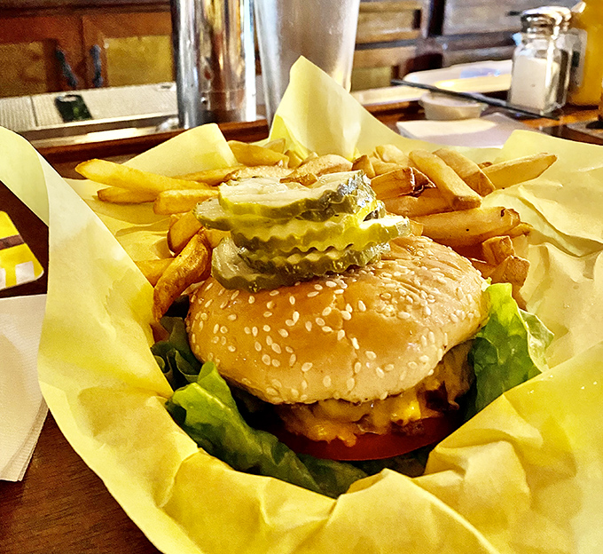The burger basket presentation&mdash;unpretentious yet perfect. That paper wrapper isn't just packaging; it's a time-honored tradition of proper burger service.