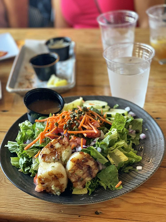 A salad that doesn't feel like punishment. Those perfectly seared scallops transform ordinary greens into something you'd actually crave rather than tolerate.
