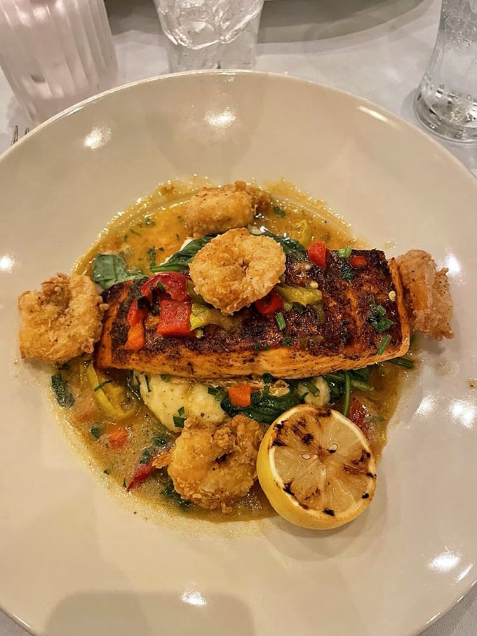 A seafood masterpiece where crispy shrimp surround salmon like loyal courtiers, all basking in a sauce worthy of royalty.