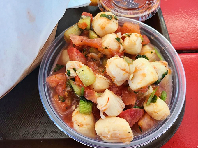 Scallop ceviche that dances with fresh tomatoes and herbs. The ocean's candy, transformed by citrus into something even more magical.