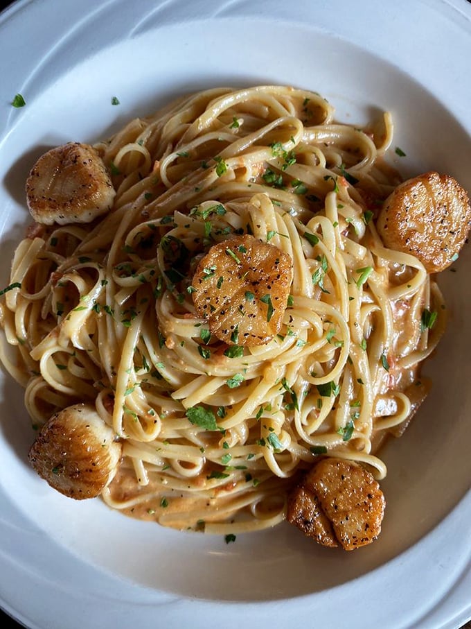 Perfectly seared scallops stand guard around linguine in a creamy sauce. Pasta this good this close to the ocean feels almost rebellious. 
