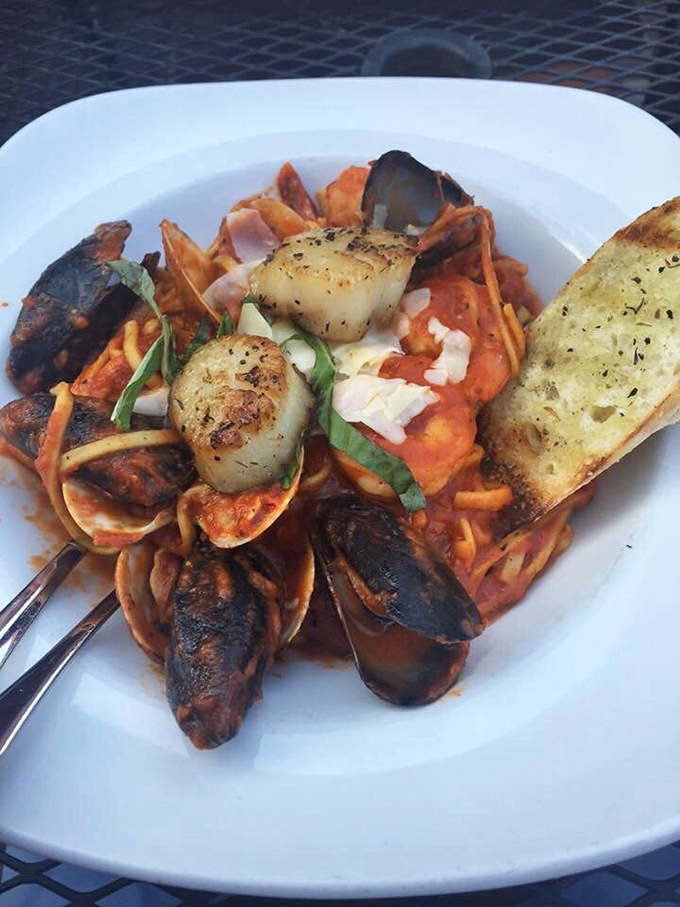 The seafood pasta that launched a thousand return trips. Those mussels aren't just hanging out&mdash;they're throwing a party with scallops in tomato sauce.