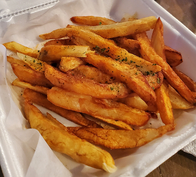 These aren't fries; they're golden batons of crispy perfection dusted with herbs like edible confetti.