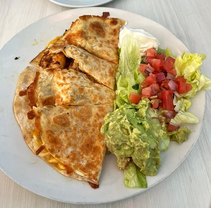 This quesadilla doesn't just have cheese&mdash;it's having a full-on fiesta with guacamole and pico de gallo joining the party on your plate.