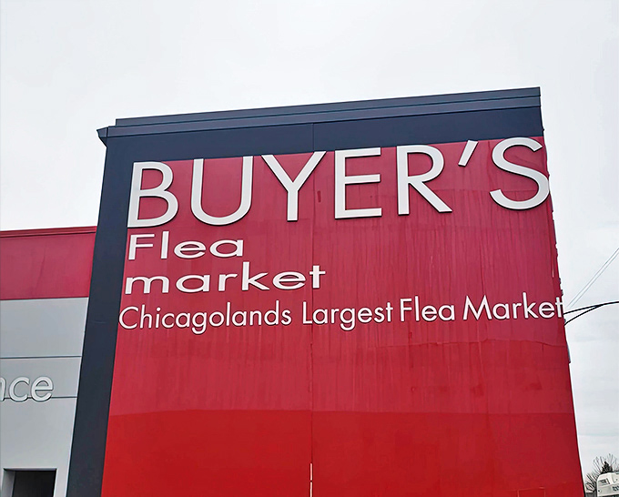 The market's signature red announces itself from blocks away &ndash; architectural shorthand for "your wallet is about to get lighter."