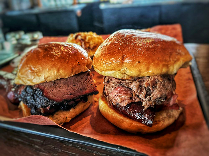 Two brisket sandwiches sitting pretty on their tray&mdash;the kind of lunch that requires a nap afterward and zero regrets.