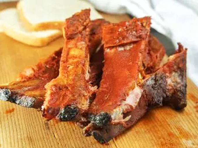 These ribs have the kind of bark that makes tree bark jealous. The perfect balance of char, meat, and that signature Parks sauce.