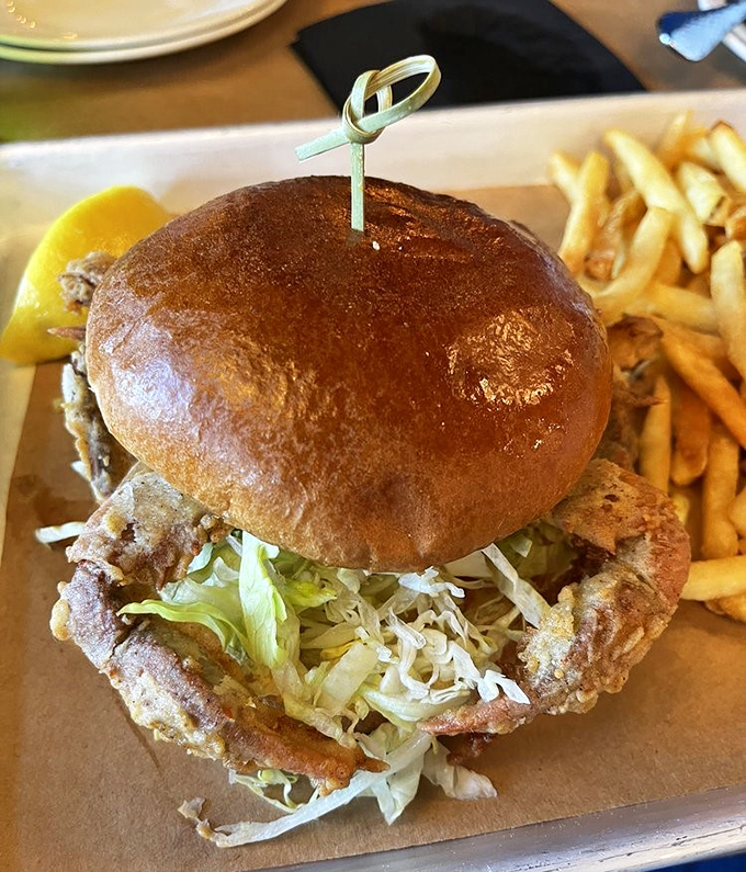 This soft shell crab sandwich is what happens when the ocean decides to high-five a brioche bun. The crispy legs peeking out are just showing off.