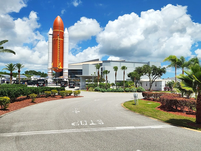 The Space Shuttle Atlantis exhibit showcases the workhorse of NASA's fleet, its orange external tank vibrant against Florida's blue sky.