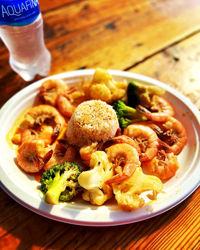 A plate of plump, spiced shrimp surrounded by colorful vegetables – like a seafood party where everyone's invited.