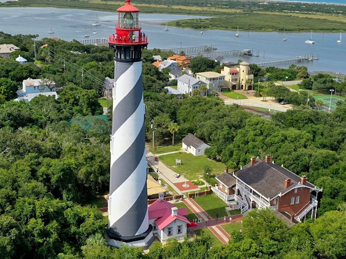 The St. Augustine Lighthouse's candy-cane spiral has guided mariners home since 1874, standing tall like a barbershop pole for giants.