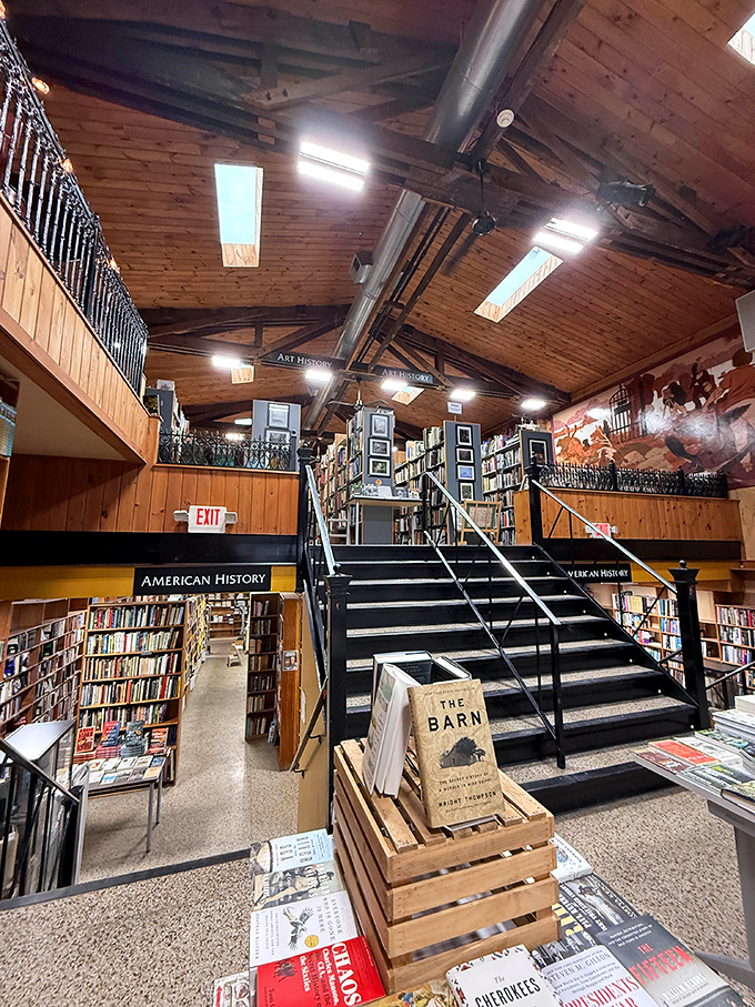 The staircase isn't just functional—it's a literary Yellow Brick Road leading to even more wonderlands of words upstairs.