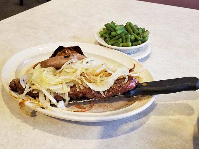 
A steak that's not trying to impress anyone but somehow impresses everyone, topped with onions caramelized to sweet perfection. 