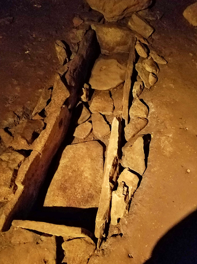 This stone formation inside the cave resembles an ancient burial site, adding another layer of mystery to the already spine-tingling experience.