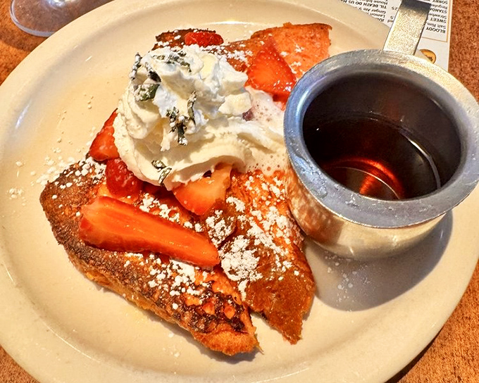 French toast that looks like it's auditioning for a dessert role but shows up for breakfast duty&mdash;strawberries never had it so good.