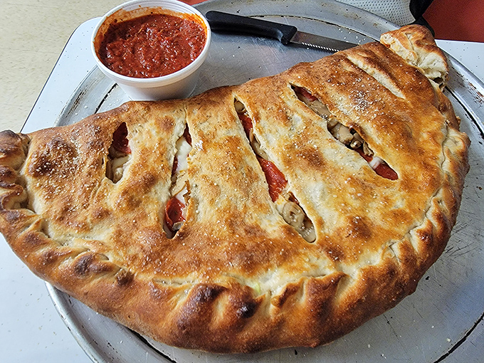 Stromboli stuffed with enough cheese and goodness to feed a small Italian village or one very happy customer.