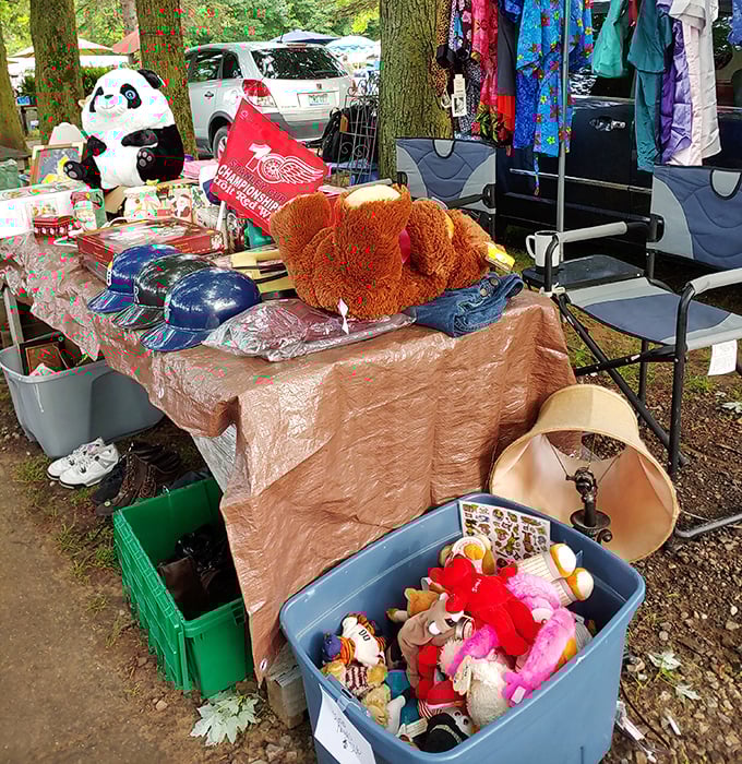 Stuffed animals and sports memorabilia share table space, waiting for new homes where they'll become someone's prized possession.