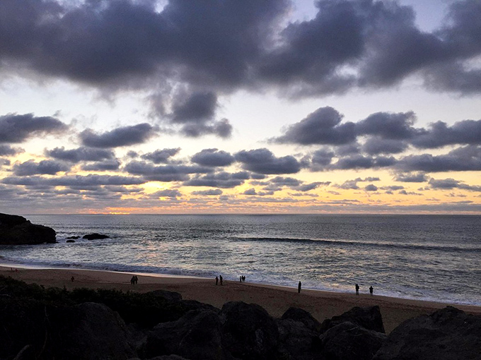 Sunset transforms Montara's beach into nature's light show, painting clouds in impossible colors while waves provide the applause.