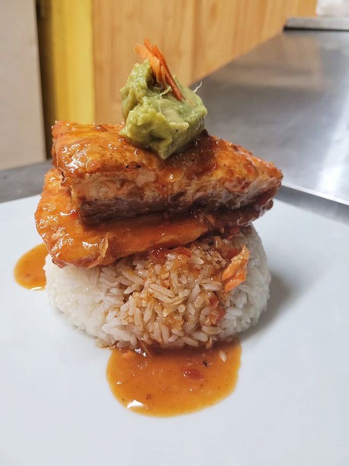 Sweet chili salmon perched atop rice like a tropical sunset. That dollop of avocado? The perfect cool counterpoint to the heat.