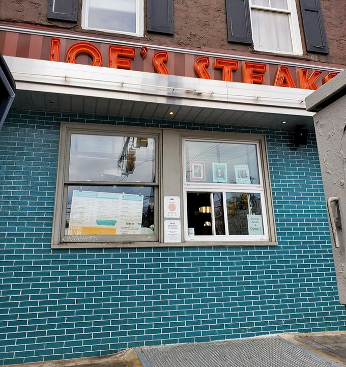 The takeout window: where hope and hunger meet, framed by that distinctive turquoise tile that's become a Philly landmark.