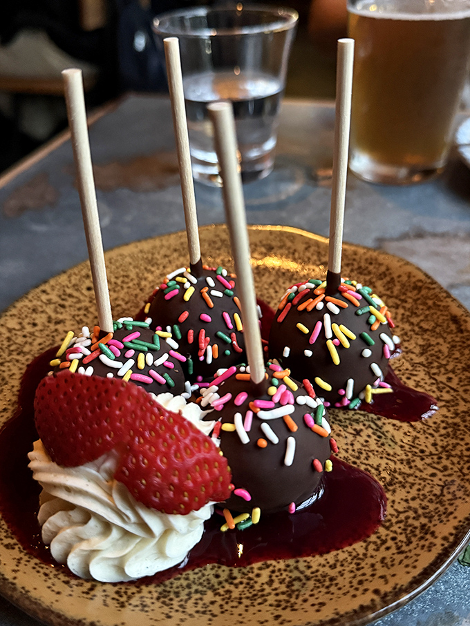 Chocolate cake pops with rainbow sprinkles &ndash; because sometimes the most sophisticated dessert is the one that makes you smile like you're eight years old again.