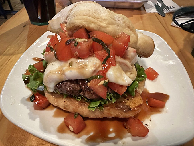 The Tuscany Burger arrives like an edible postcard from Italy&mdash;fresh tomato bruschetta and melted cheese creating a vacation between two buns.