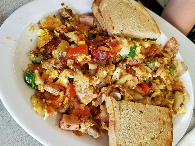The Ultimate Herb Nelson&mdash;a glorious breakfast mountain where eggs, potatoes, and every breakfast meat imaginable collide in perfect harmony.
