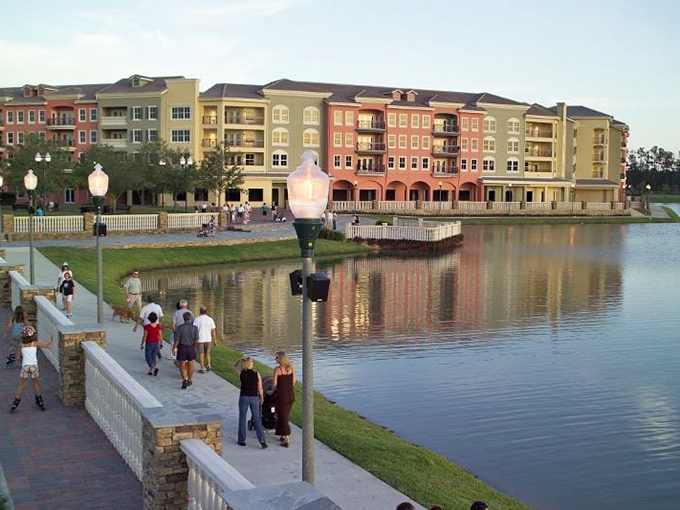 Evening brings out the promenaders along the waterfront, where conversations flow as freely as the gentle Florida breeze.