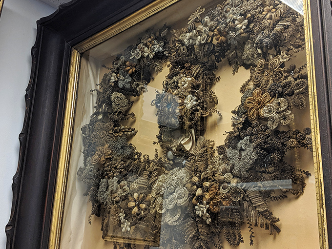 This Victorian hair wreath could pass for botanical art until you realize every petal and leaf is crafted from someone's actual locks.