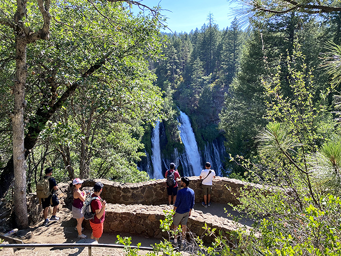 Fellow waterfall enthusiasts gather to witness nature's daily performance in this outdoor amphitheater.