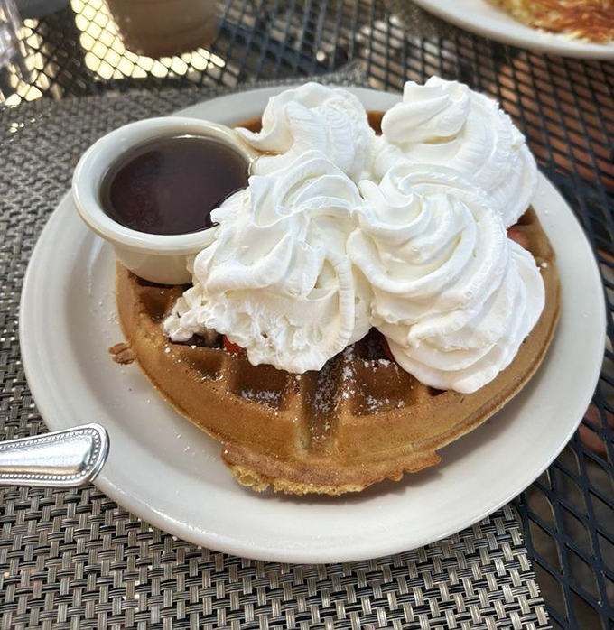 This waffle isn't just topped with whipped cream&mdash;it's wearing a cloud costume. Breakfast theater at its finest.