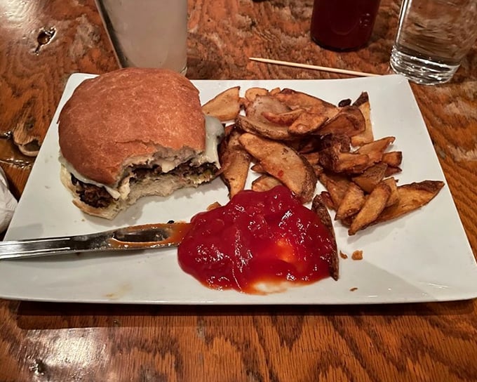 This isn't just lunch; it's edible architecture where every layer&mdash;from melted cheese to hand-cut fries to that vibrant sauce&mdash;plays a crucial supporting role.