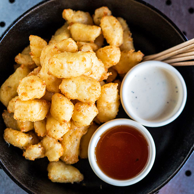 Wisconsin cheese curds that have clearly found their California calling. Crispy outside, gooey inside&mdash;like the best of us.