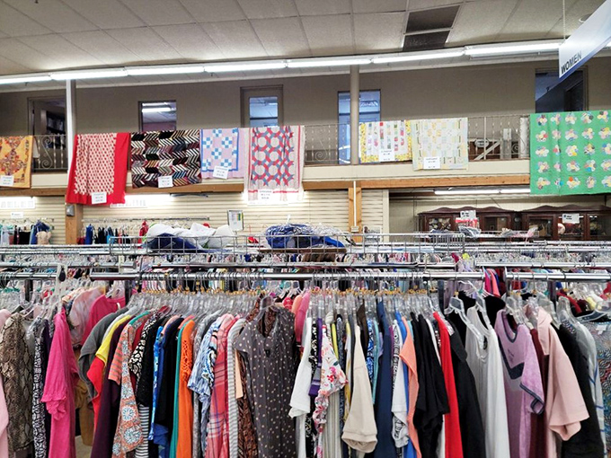 Clothing racks stretch to the horizon beneath handmade quilts. Fashion archaeology at its finest&mdash;dig deep enough and find vintage gold.