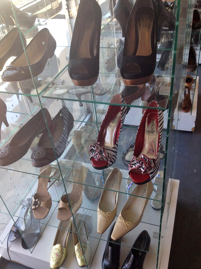 Glass shelves showcase footwear fantasies from practical flats to party-ready heels. Cinderella found her slipper; you might find several.